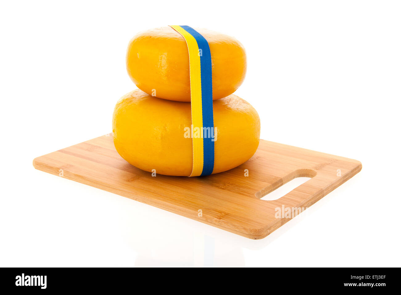 Two stacked whole Swedish cheeses isolated over white background Stock ...