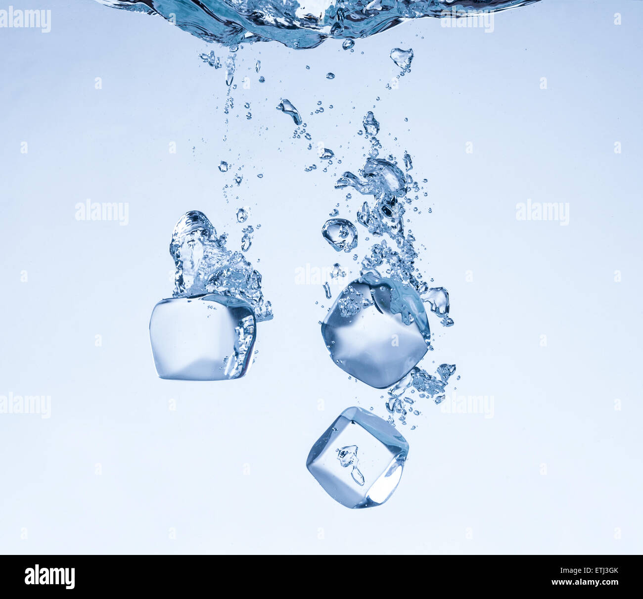 Falling ice cubes in water splashes Stock Photo - Alamy