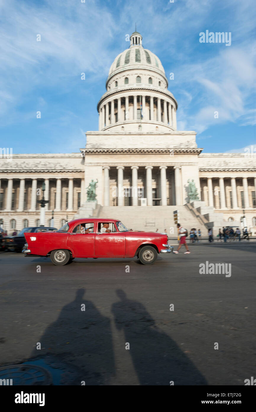 HAVANA, CUBA - JUNE 2011: Pedestrians pass in front of classic American ...