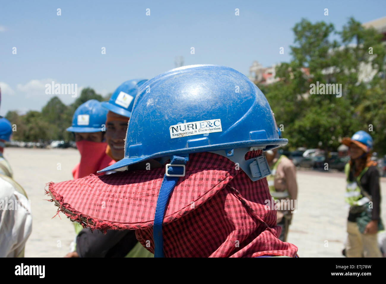 Construction workers take part in stretching exercises to enhance ...