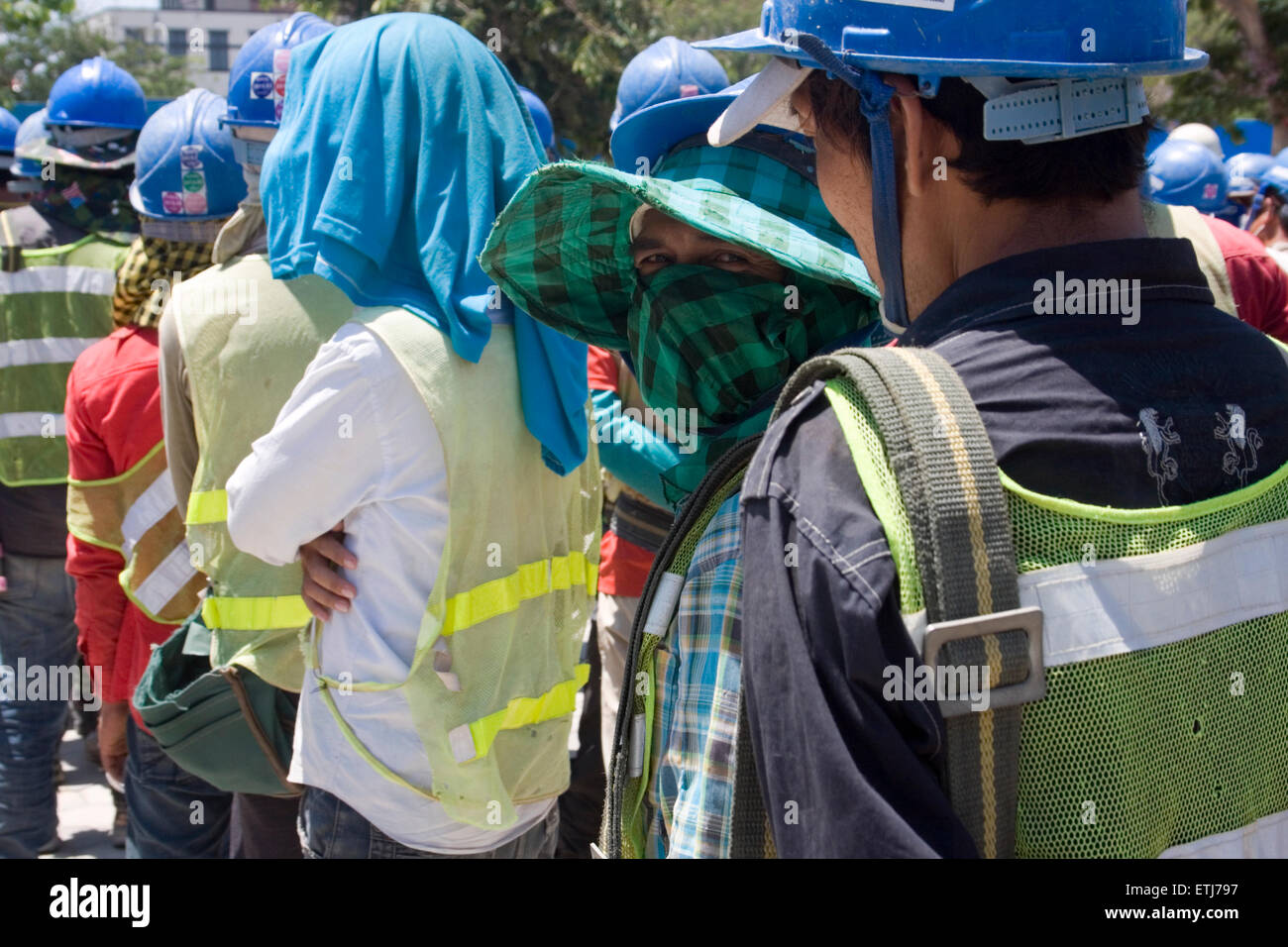 Construction workers take part in stretching exercises to enhance ...