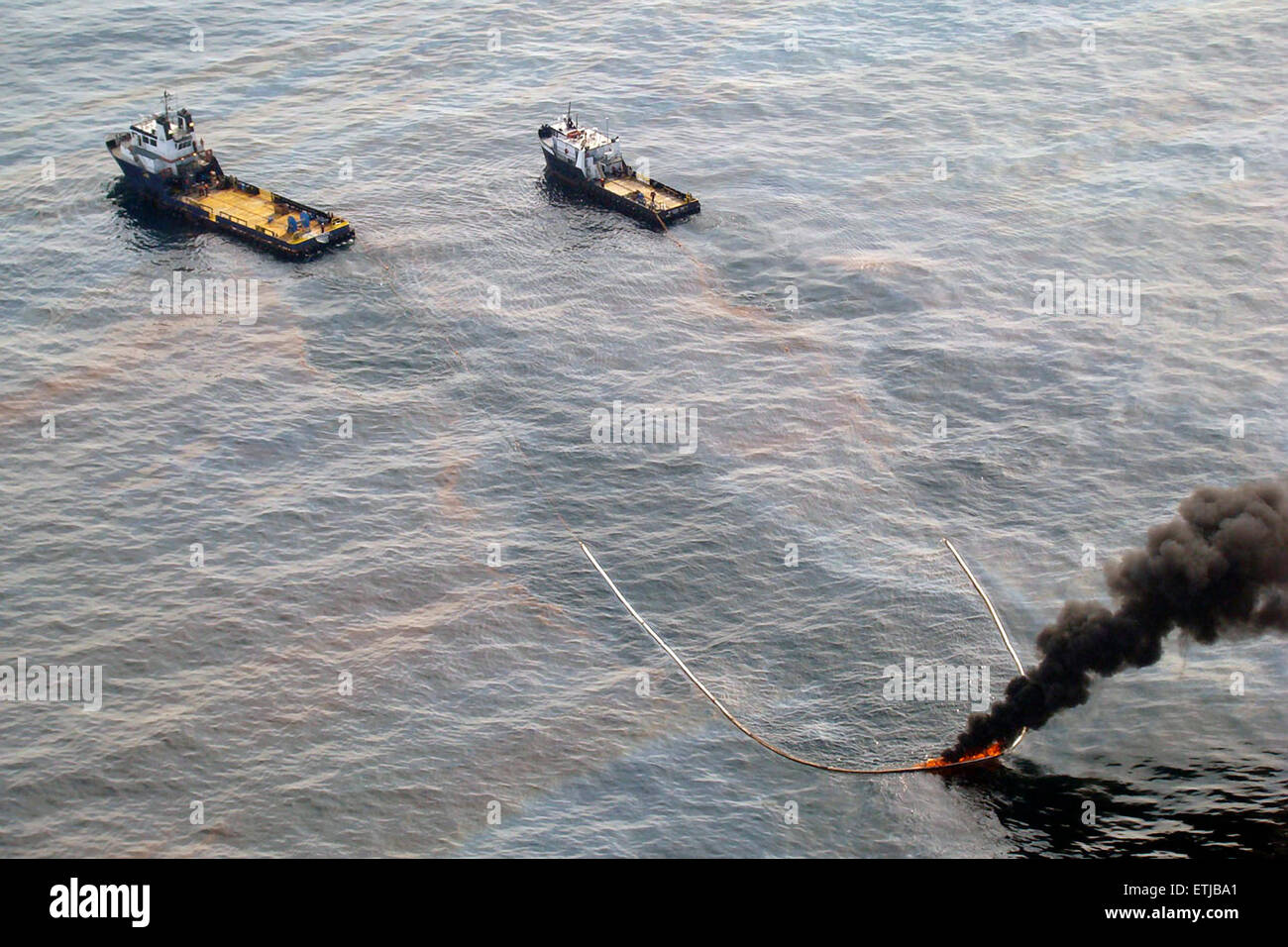 Clean up crews conduct controlled burns of oil gathered from the ...