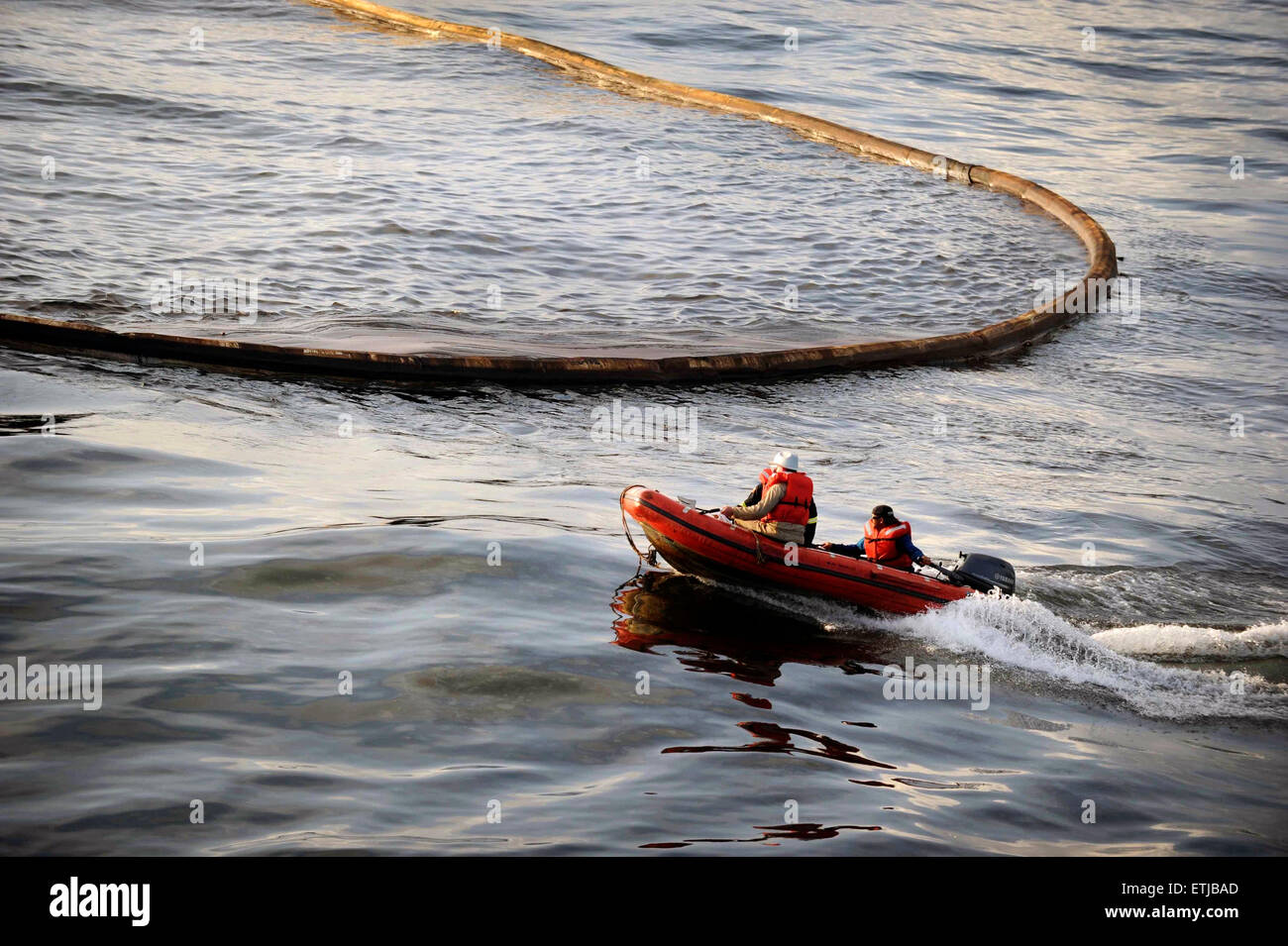 Clean up crews inspect a fire boom before conducting controlled burns ...