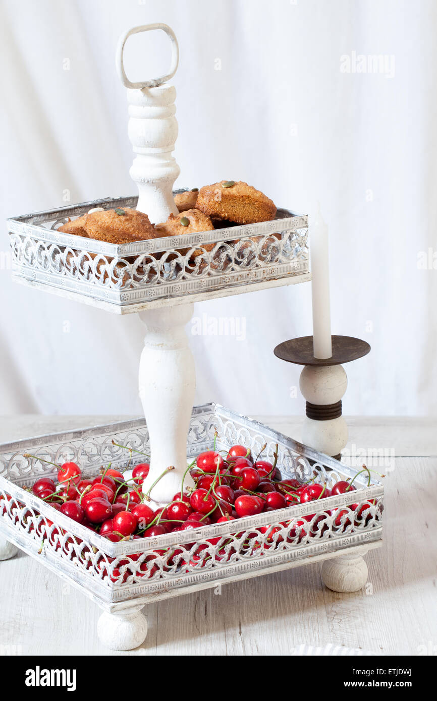 Cookie stand with cherries and heart shaped cookies Stock Photo - Alamy