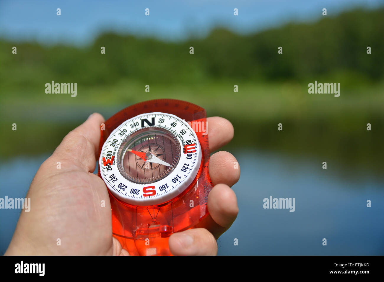 Compass in hand. Magnetic compass is in the hand of the person on a ...