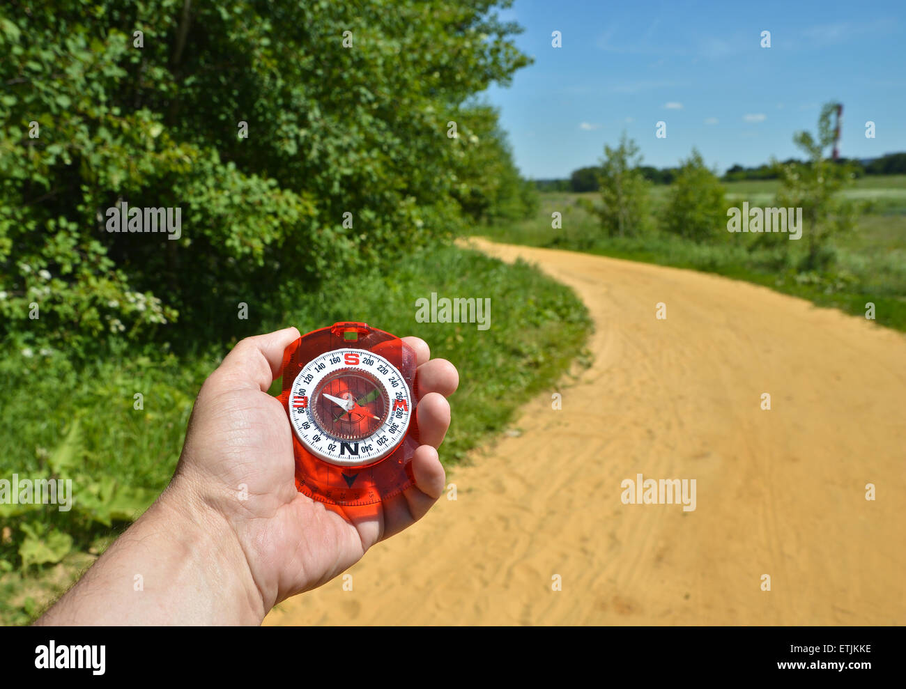 Compass in hand. Magnetic compass is in the hand of the person on a ...