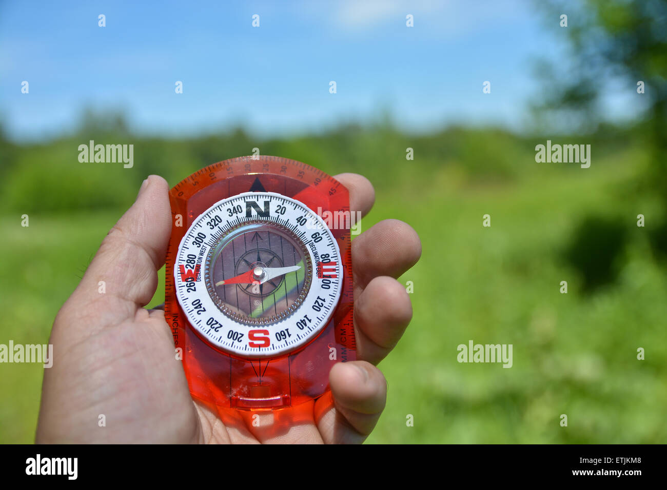 Compass in hand. Magnetic compass is in the hand of the person on a ...