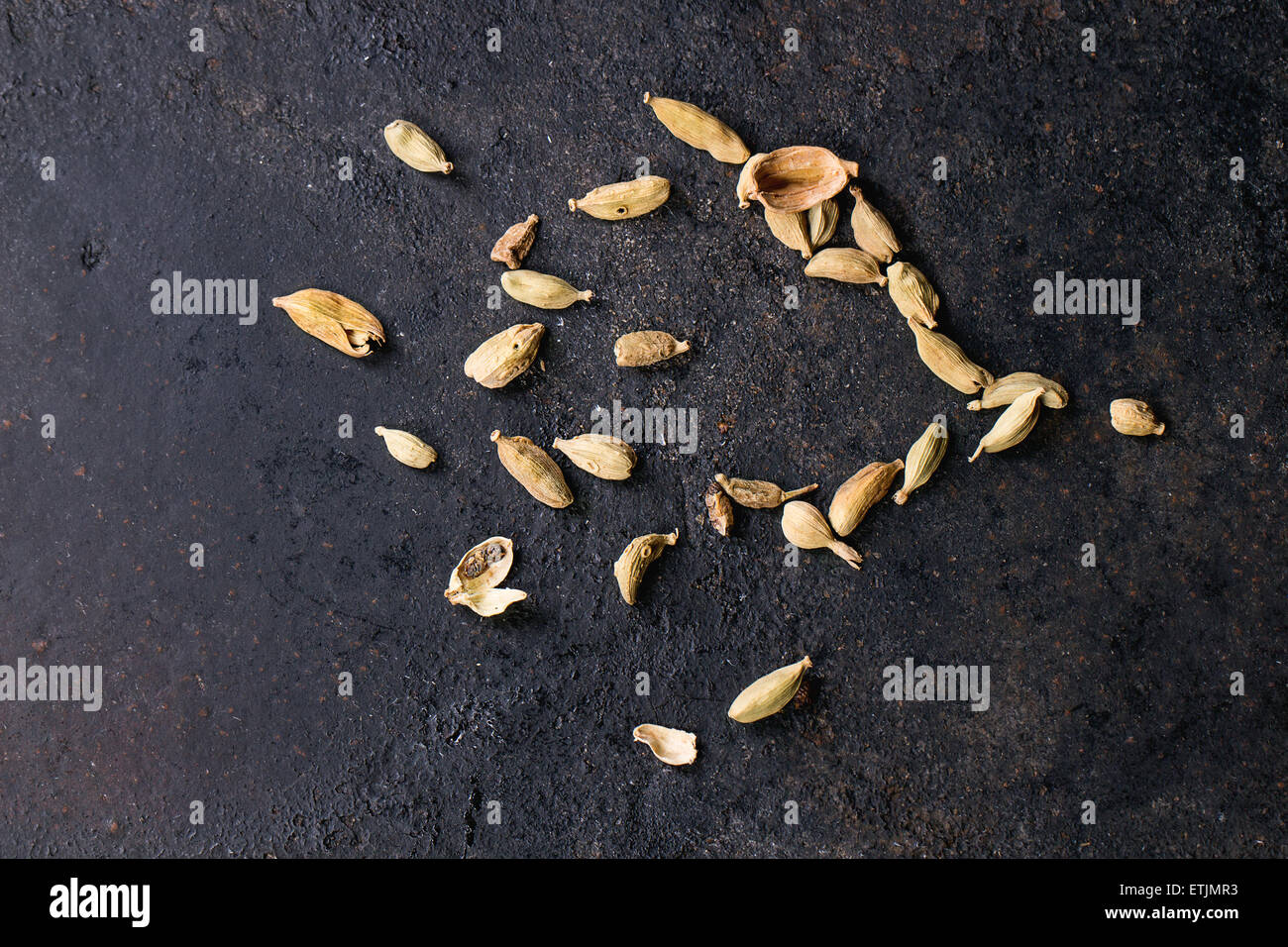 Cardamom seeds over black background Stock Photo - Alamy