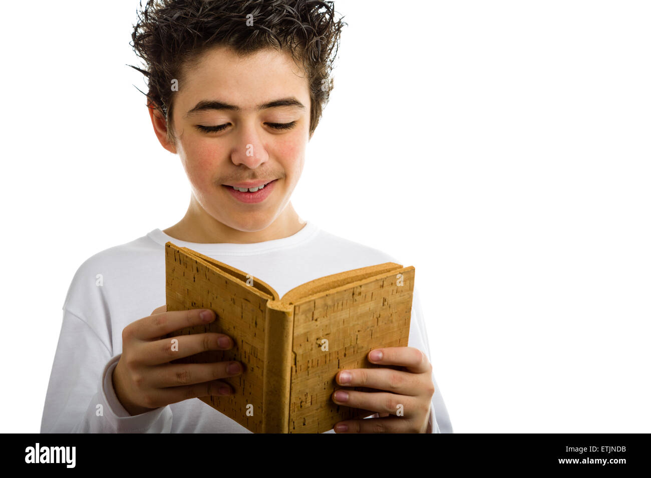 A handsome Hispanic boy smiles while reading a brown blank book made ...