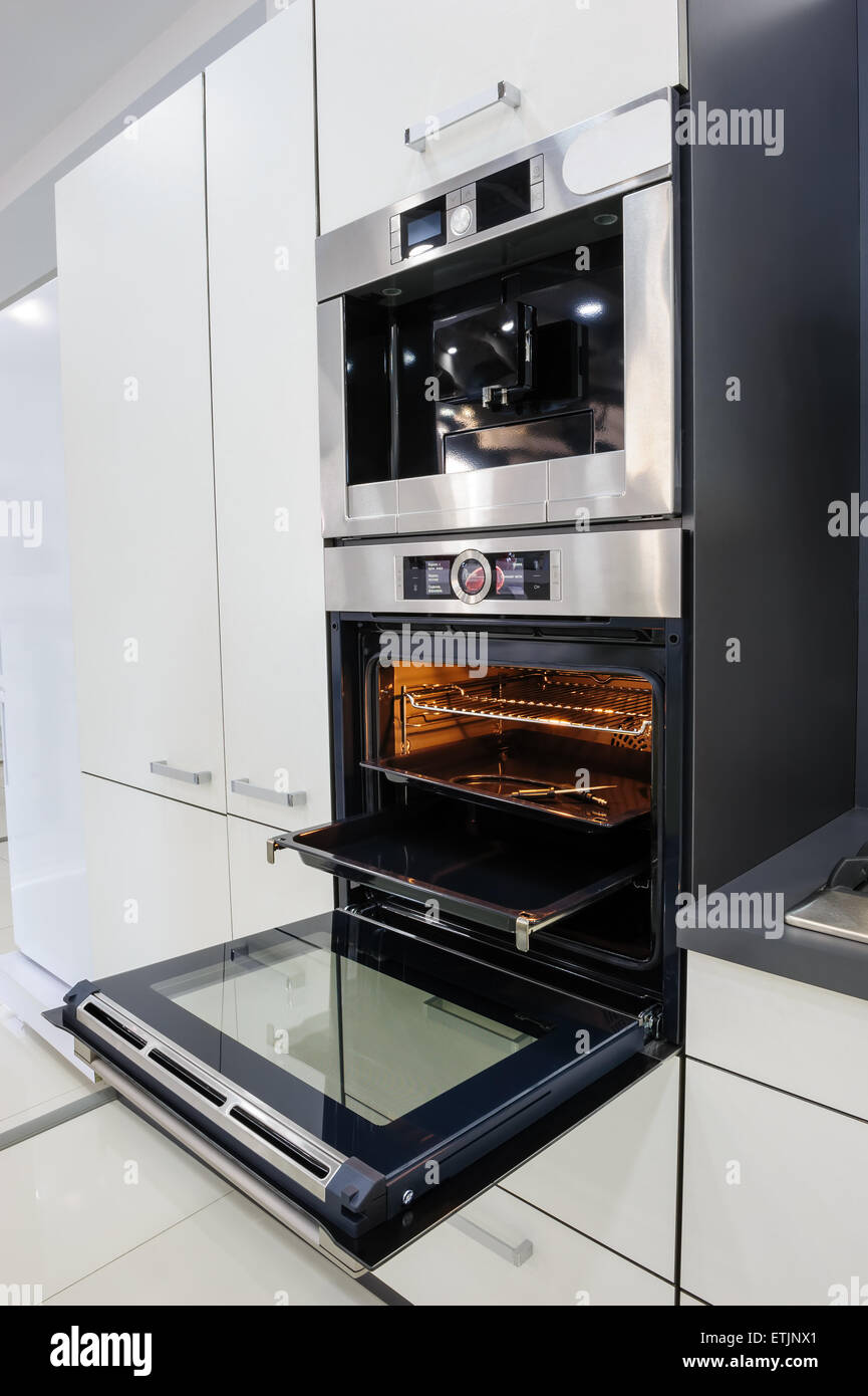 Modern hi-tek kitchen, oven with door open Stock Photo - Alamy
