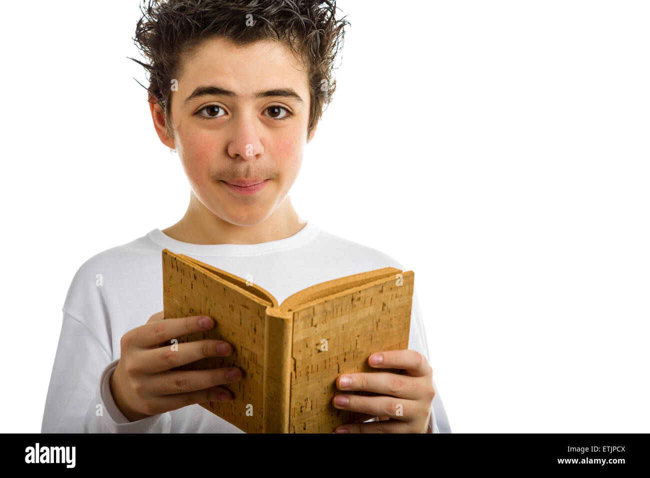A handsome Hispanic boy smiles while reading a brown blank book made ...