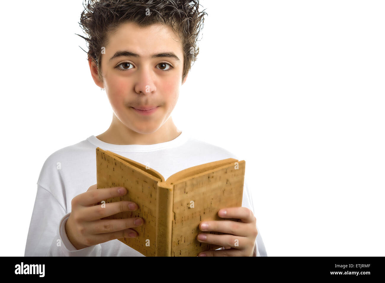 A handsome Hispanic boy smiles while reading a brown blank book made ...