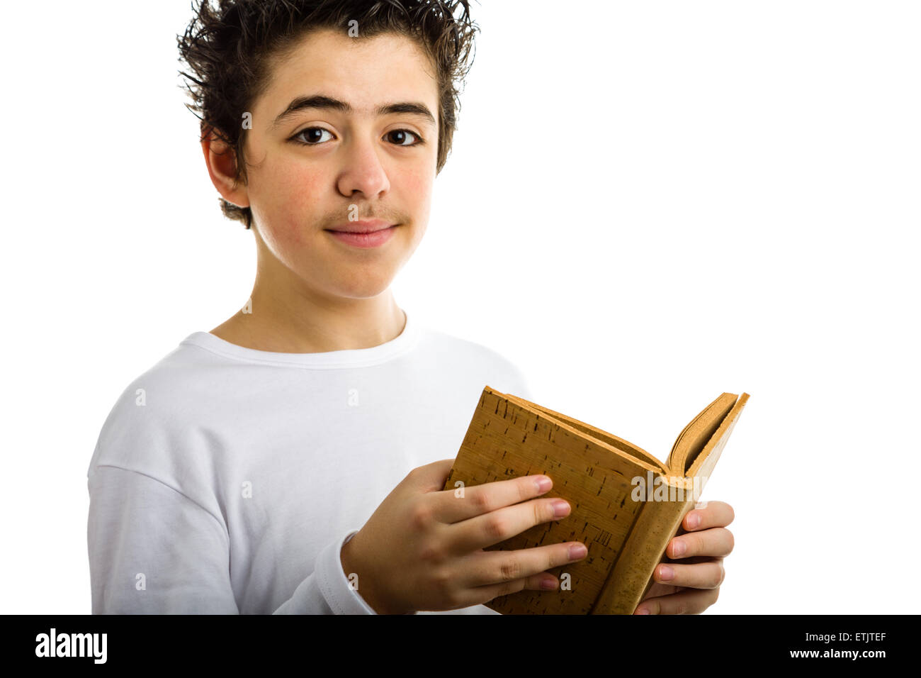 A handsome Hispanic boy smiles while reading a brown blank book made ...