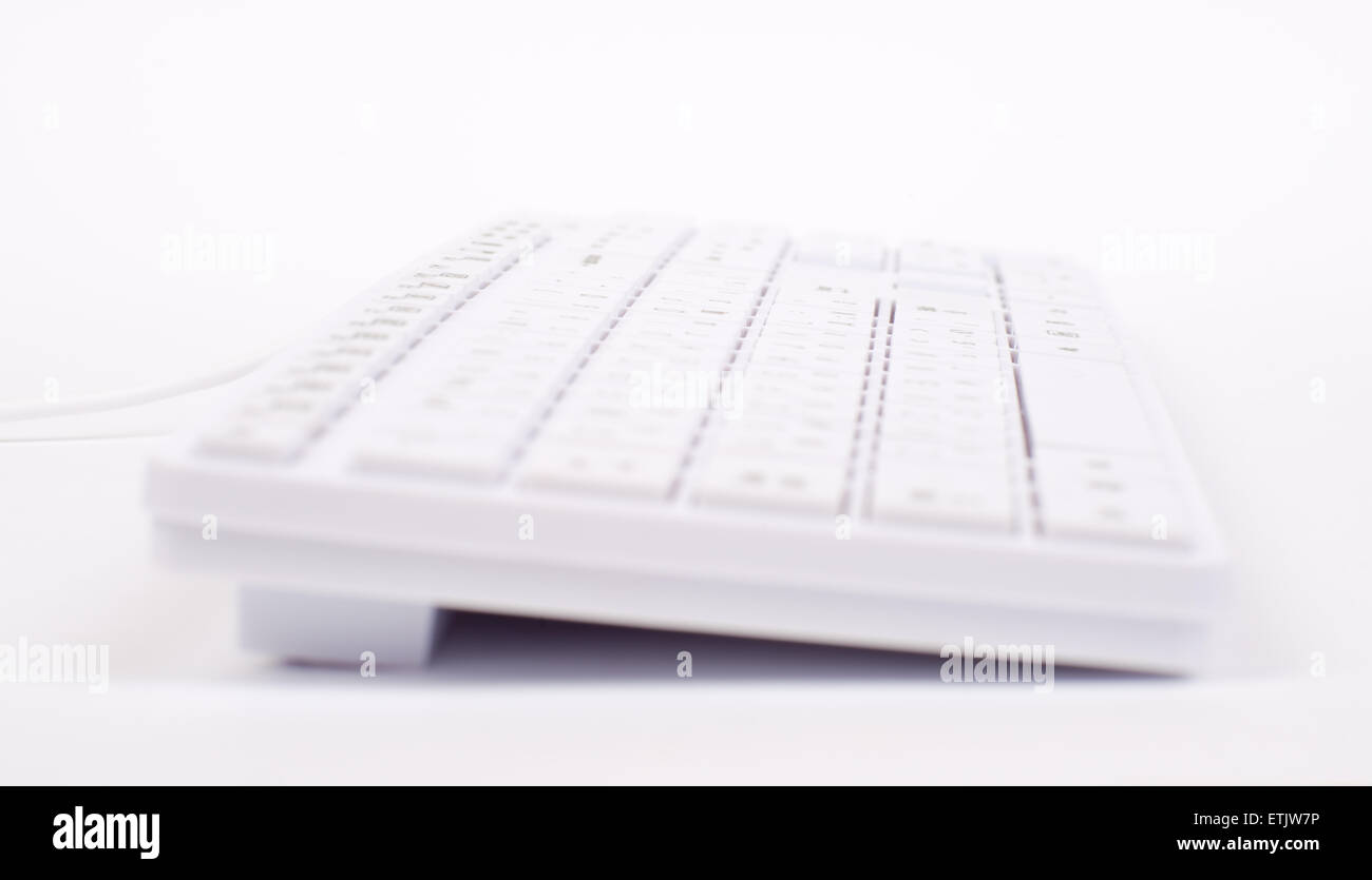 White keyboard with wire Stock Photo - Alamy