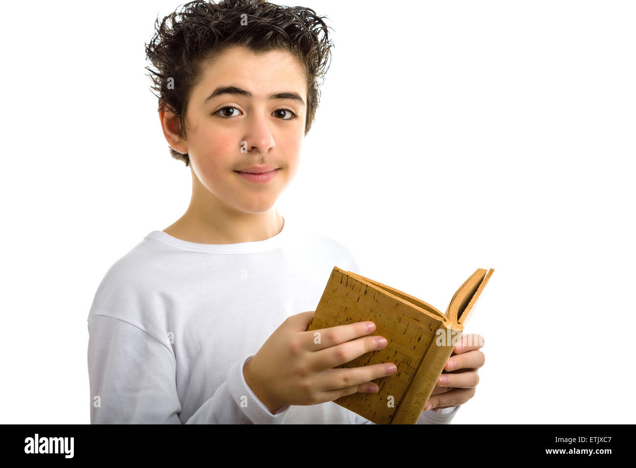 A handsome Hispanic boy smiles while reading a brown blank book made ...