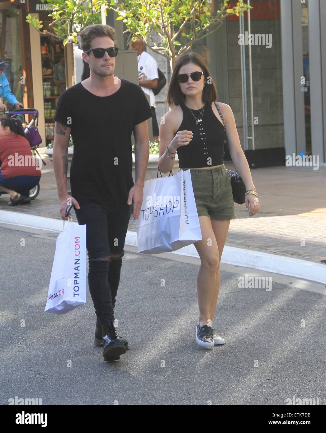 Lucy Hale and her boyfriend Adam Pitts carrying Topshop bags while ...