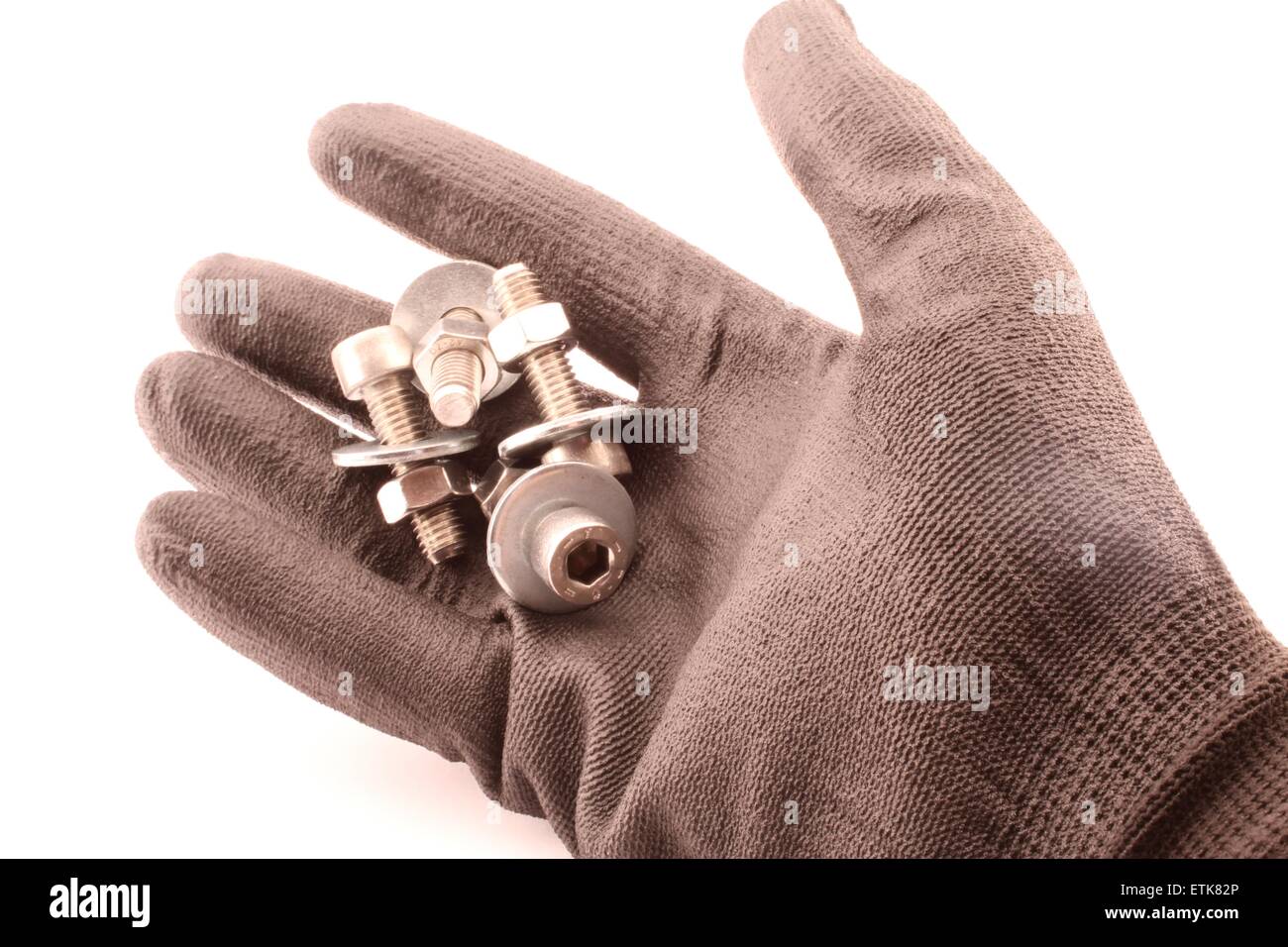 Screws and bolts mechanics, over the hand with work glove Stock Photo ...