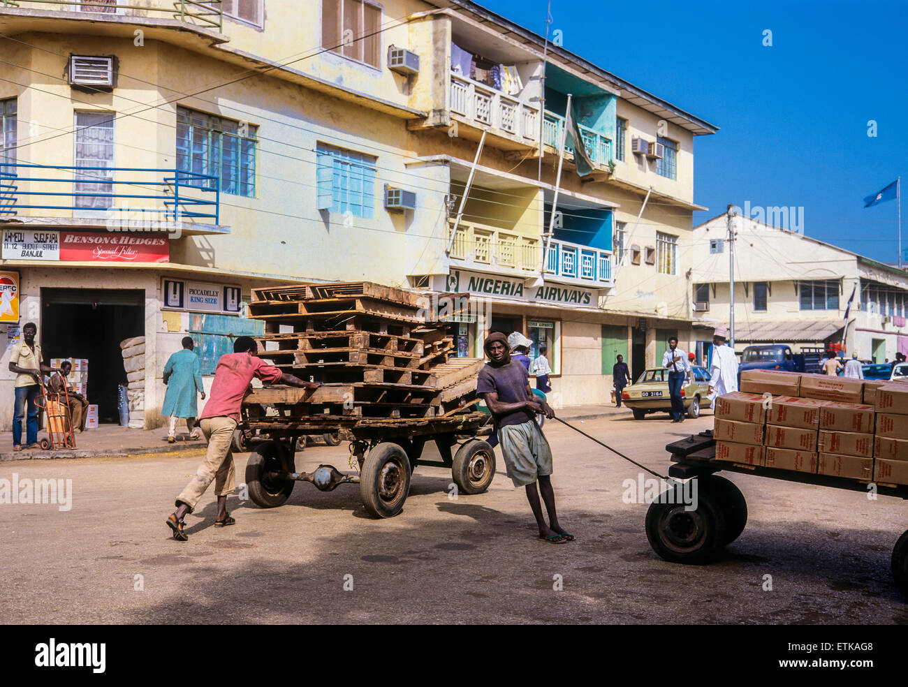 Gambian men with delivery carts, shopping street, Banjul, Gambia, West ...