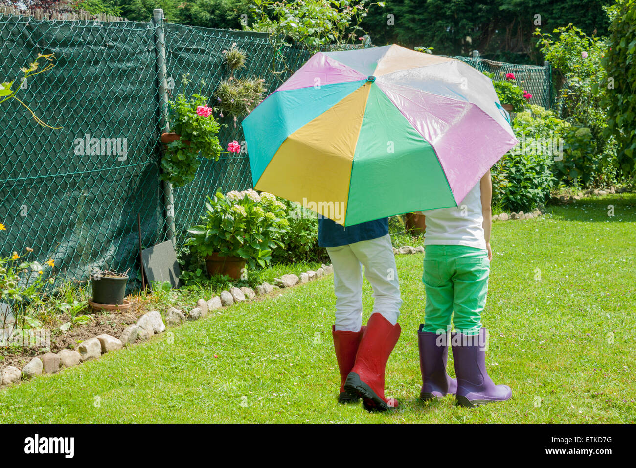 Kids playing in rain hi-res stock photography and images - Alamy
