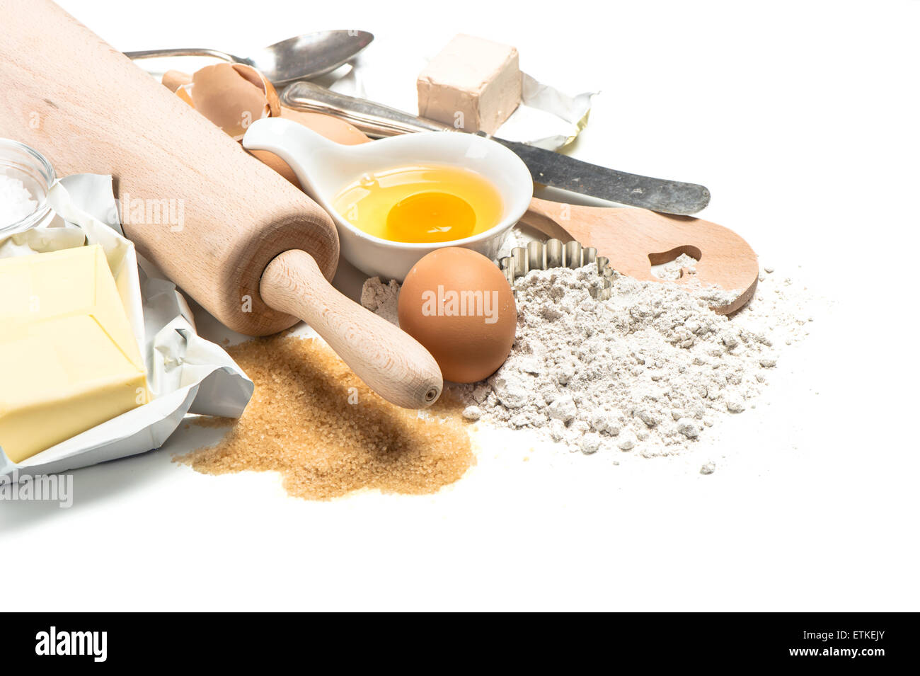 Baking ingredients flour, eggs, yeast, sugar, butter. Wooden kitchen ...