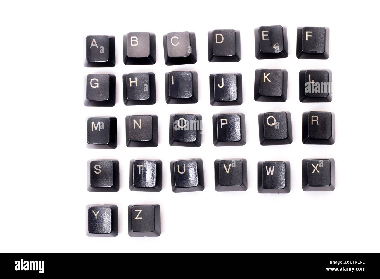 View of black computer keys on a white background forming the alphabet ...