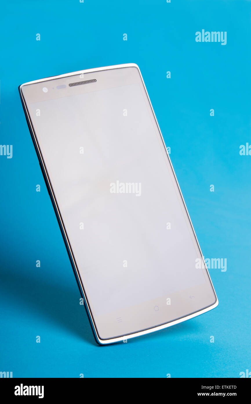 Close up view of a modern thin mobile cellphone isolated in blue ...