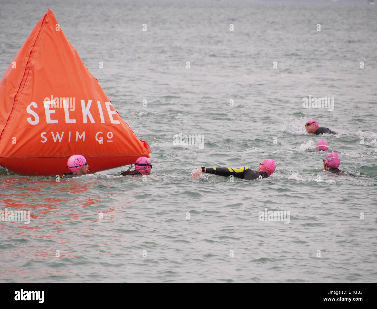 Swimmers taking part in a Triathon swim around an inflatable buoy Stock ...