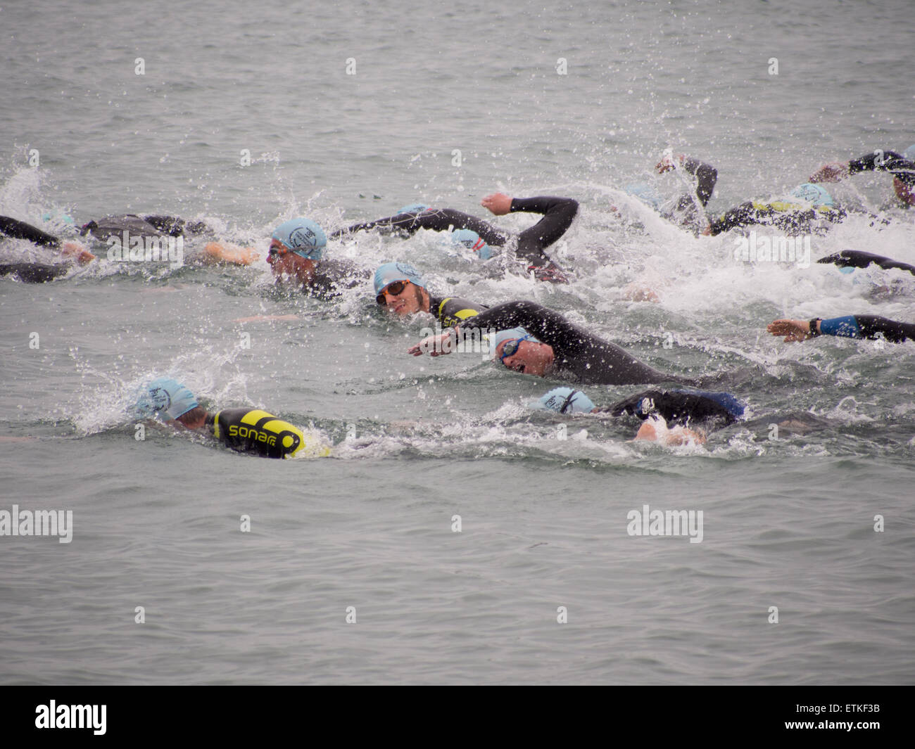 Triathletes swim in the solent, off Southsea beach, Portsmouth during a ...