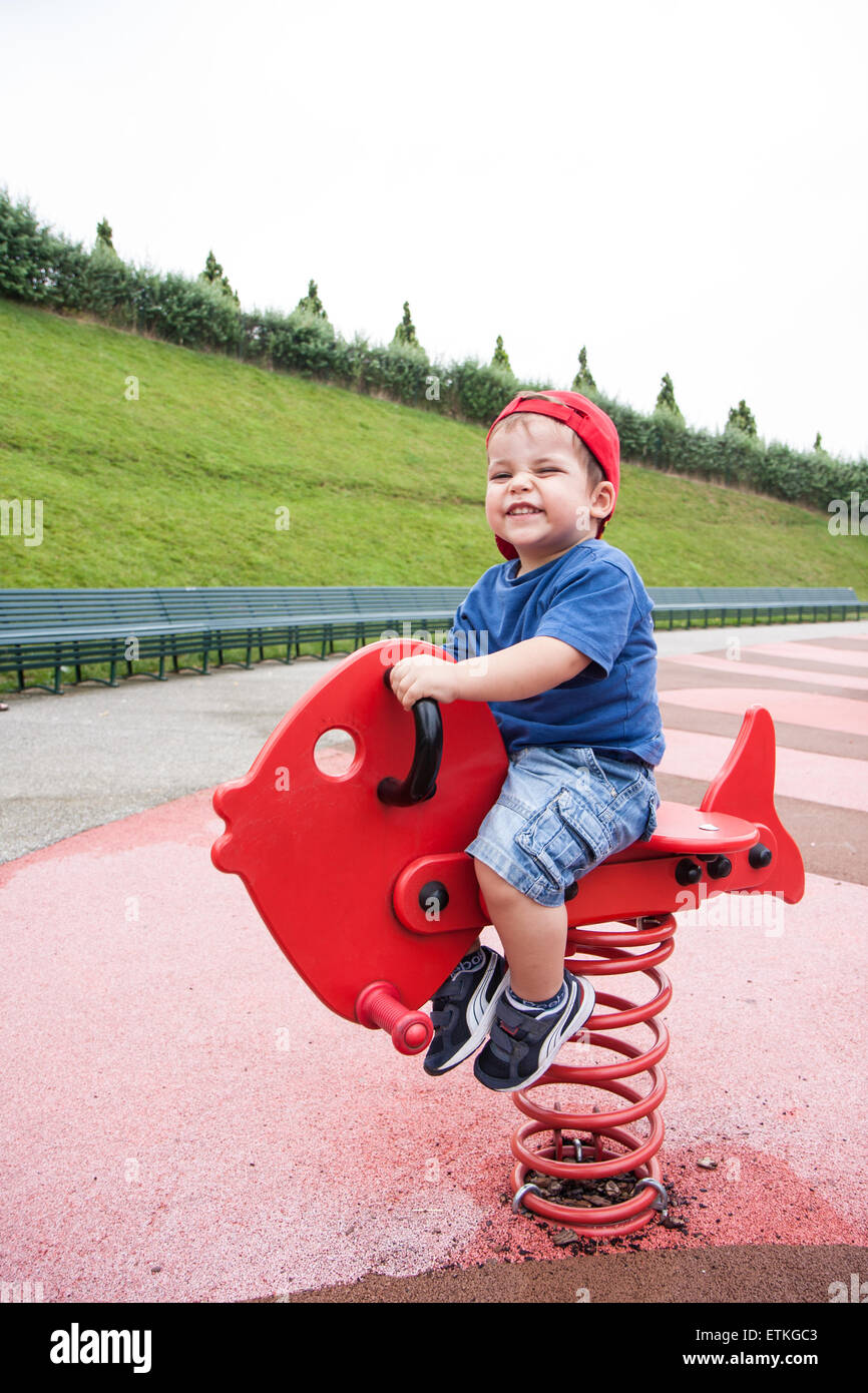 child with hat on playground spring fish Stock Photo - Alamy
