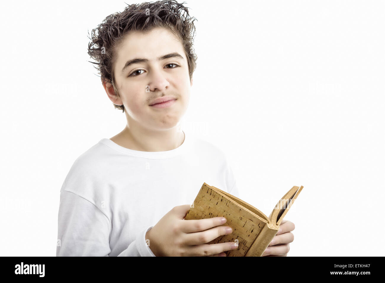 A handsome Hispanic boy shows disappointment while reading a brown ...