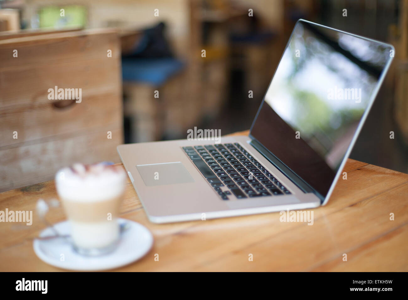 grey laptop pc computer open keyboard next to cappuccino coffee cup on ...