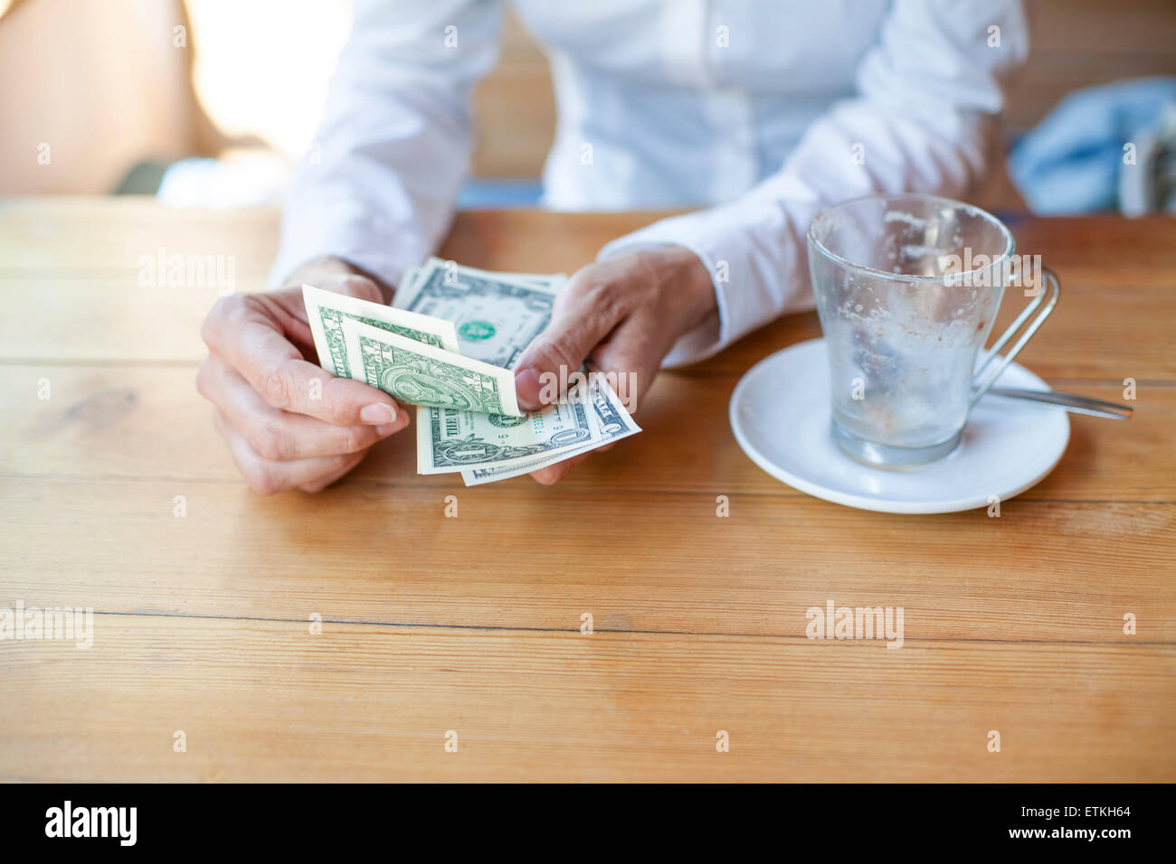 woman with white shirt ready to pay empty finished cappuccino coffee ...