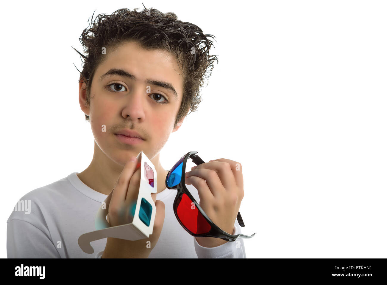 Handsome hispanic boy with questioning eyes compares vintage white 3D ...