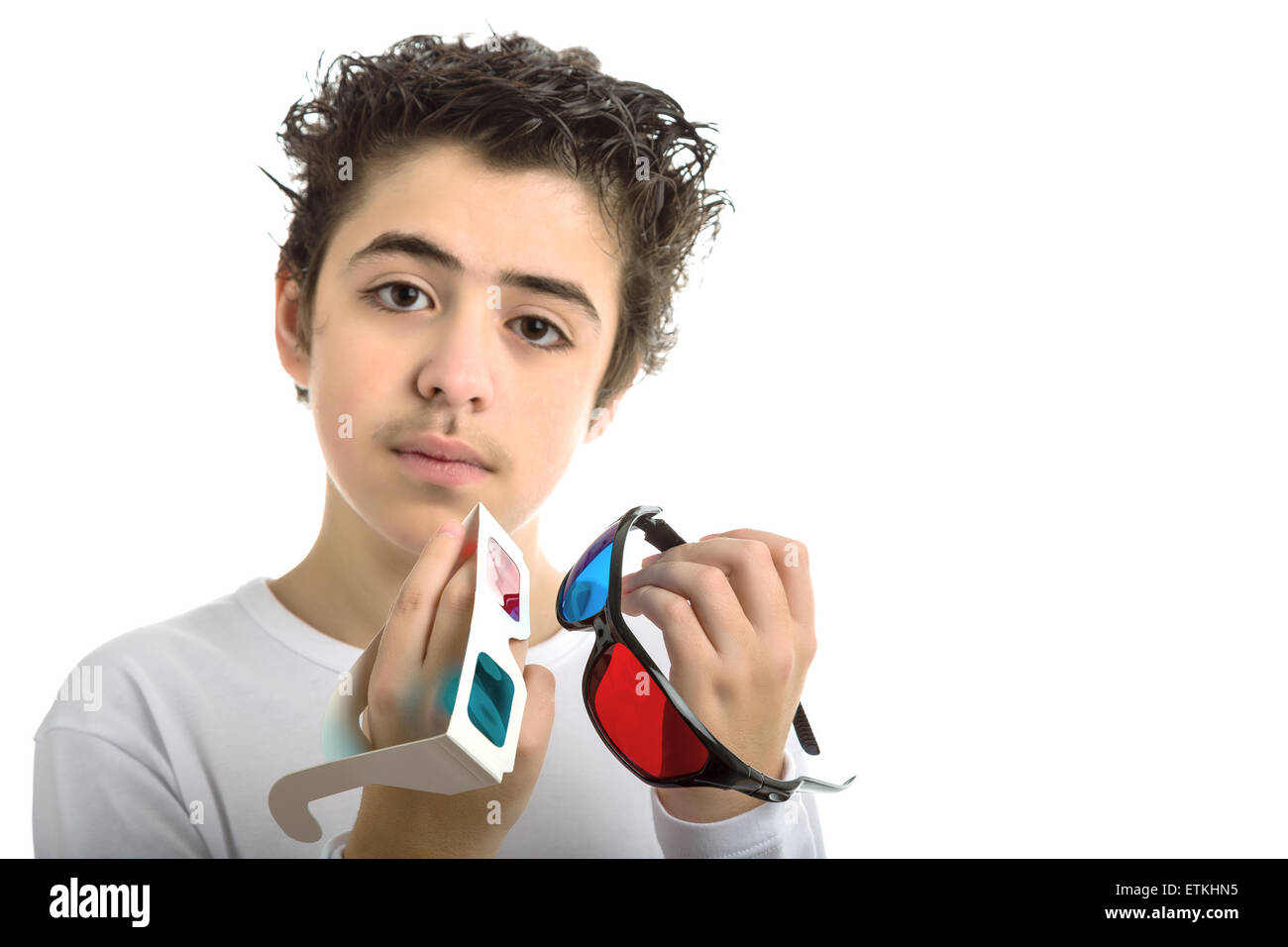 Handsome hispanic boy with questioning eyes compares vintage white 3D ...