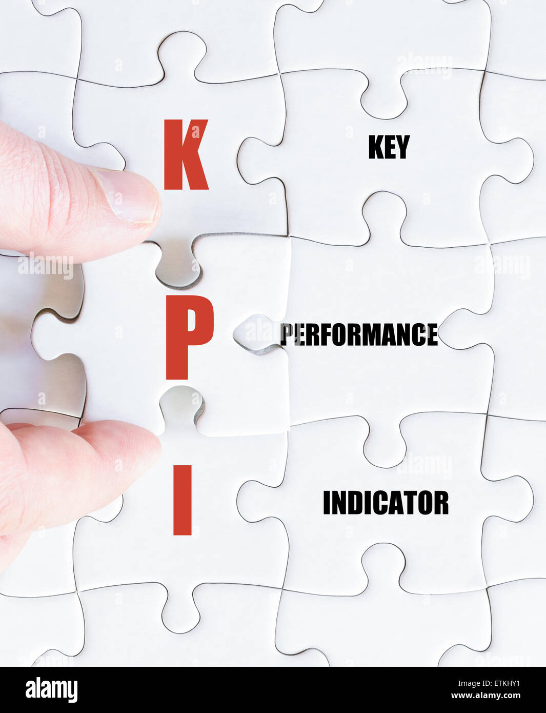 Hand of a business man completing the puzzle with the last missing ...