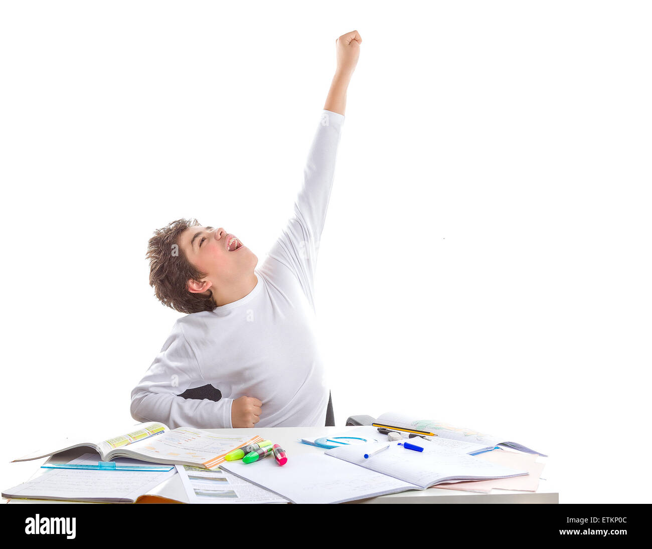 Latin Caucasian Teenager boy sitting while doing homework is happy and ...
