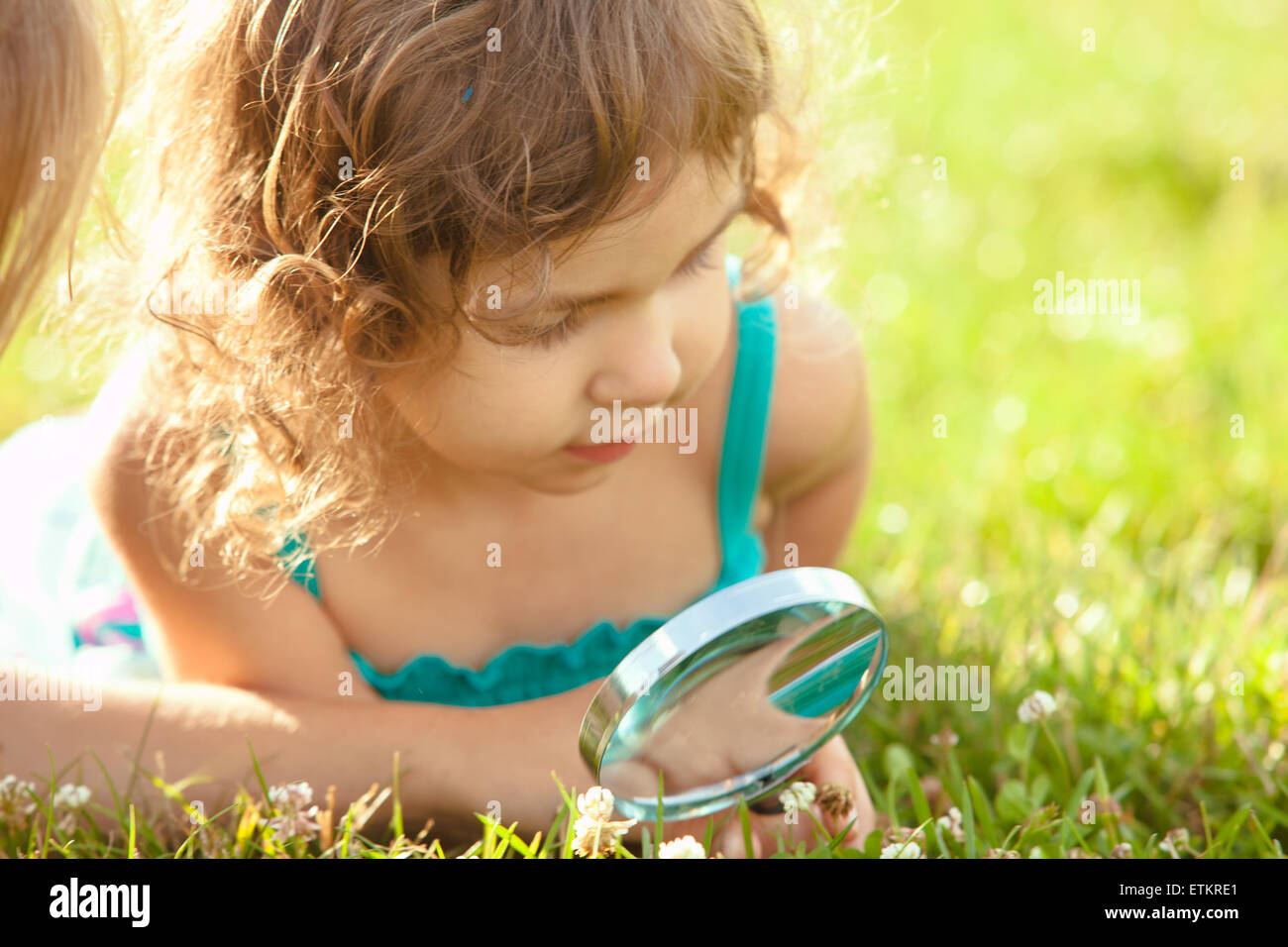 Kid with magnifying glass Stock Photo - Alamy