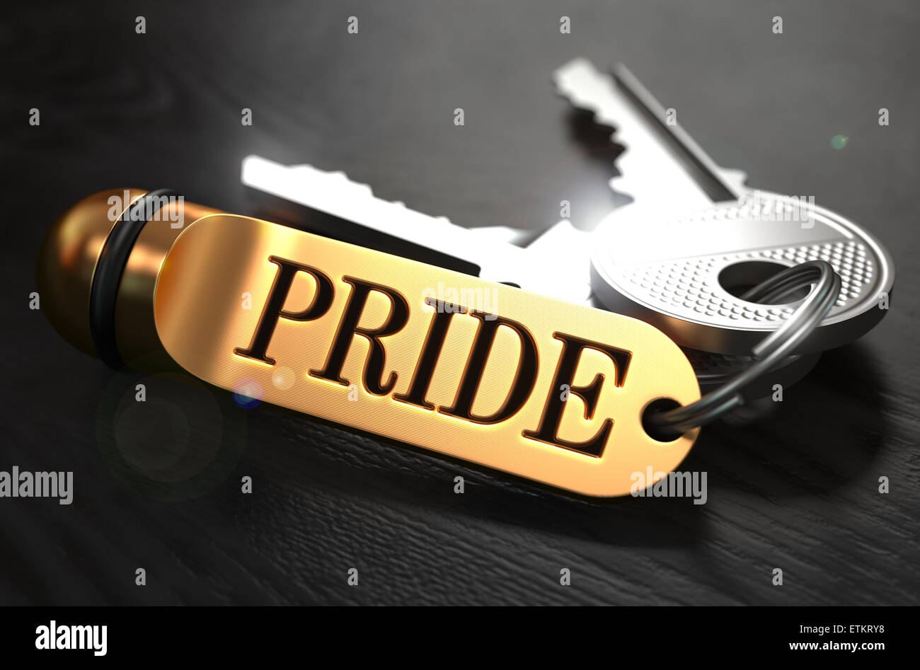 Pride written on Golden Keyring Stock Photo - Alamy