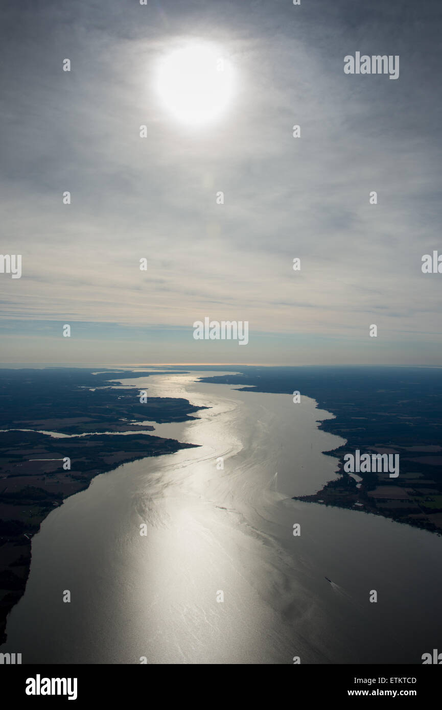 Aerial of river, showing the sun's reflection as a glowing shine in the ...