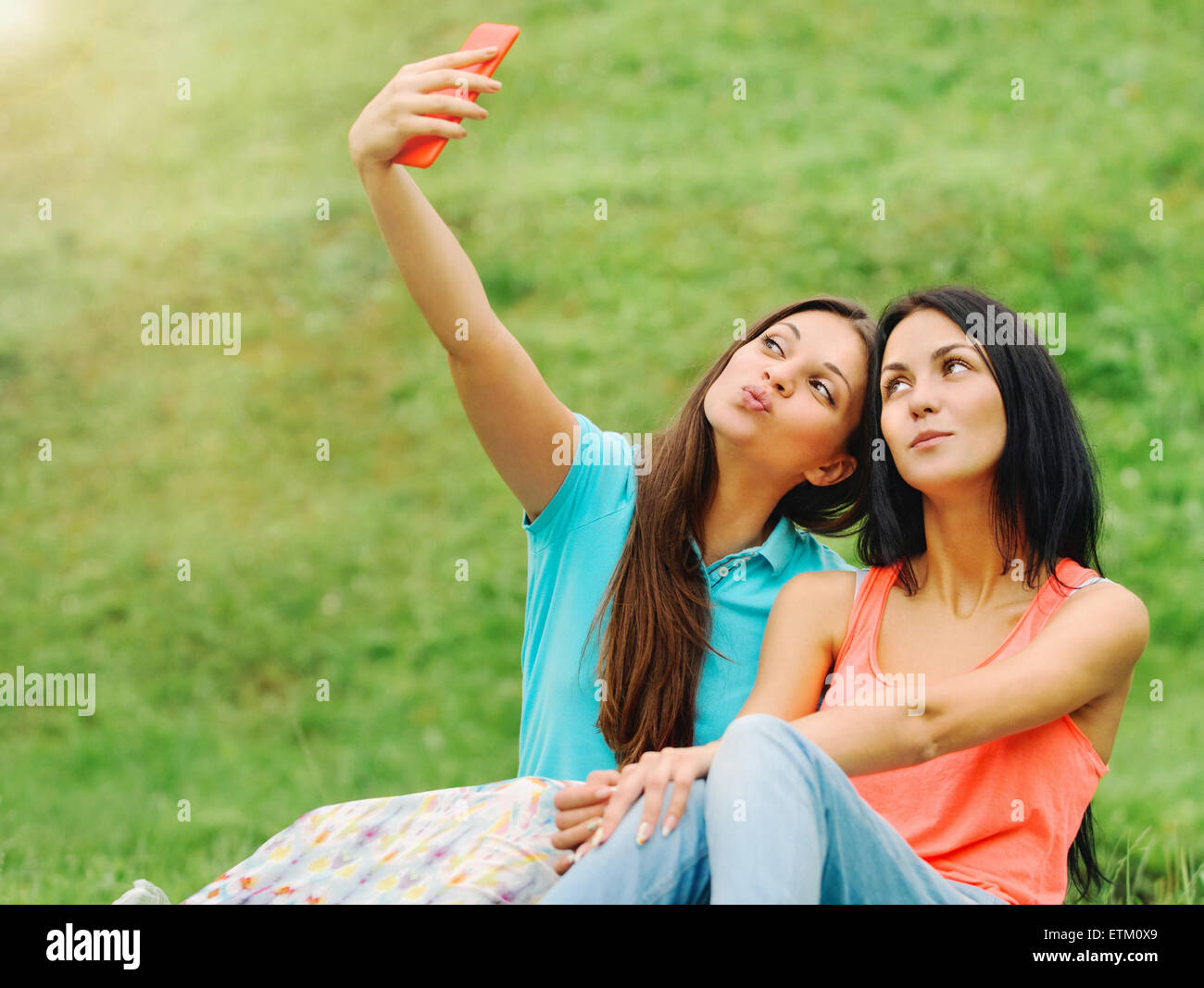 Two Happy Women Friends Laughing And Sharing Social Media Pictures In A