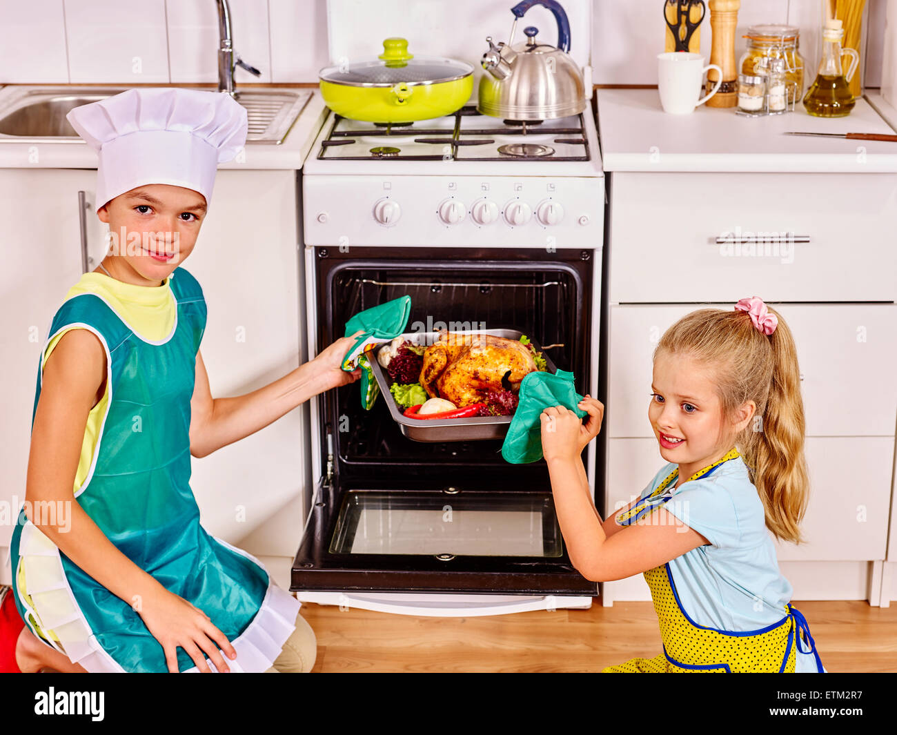 Children cooking chicken at kitchen Stock Photo - Alamy