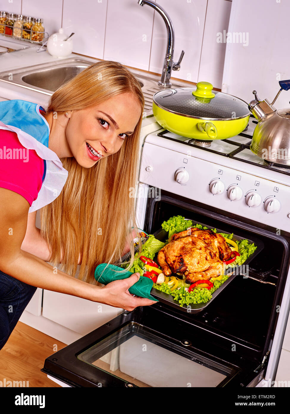 Woman cooking chicken at kitchen Stock Photo - Alamy