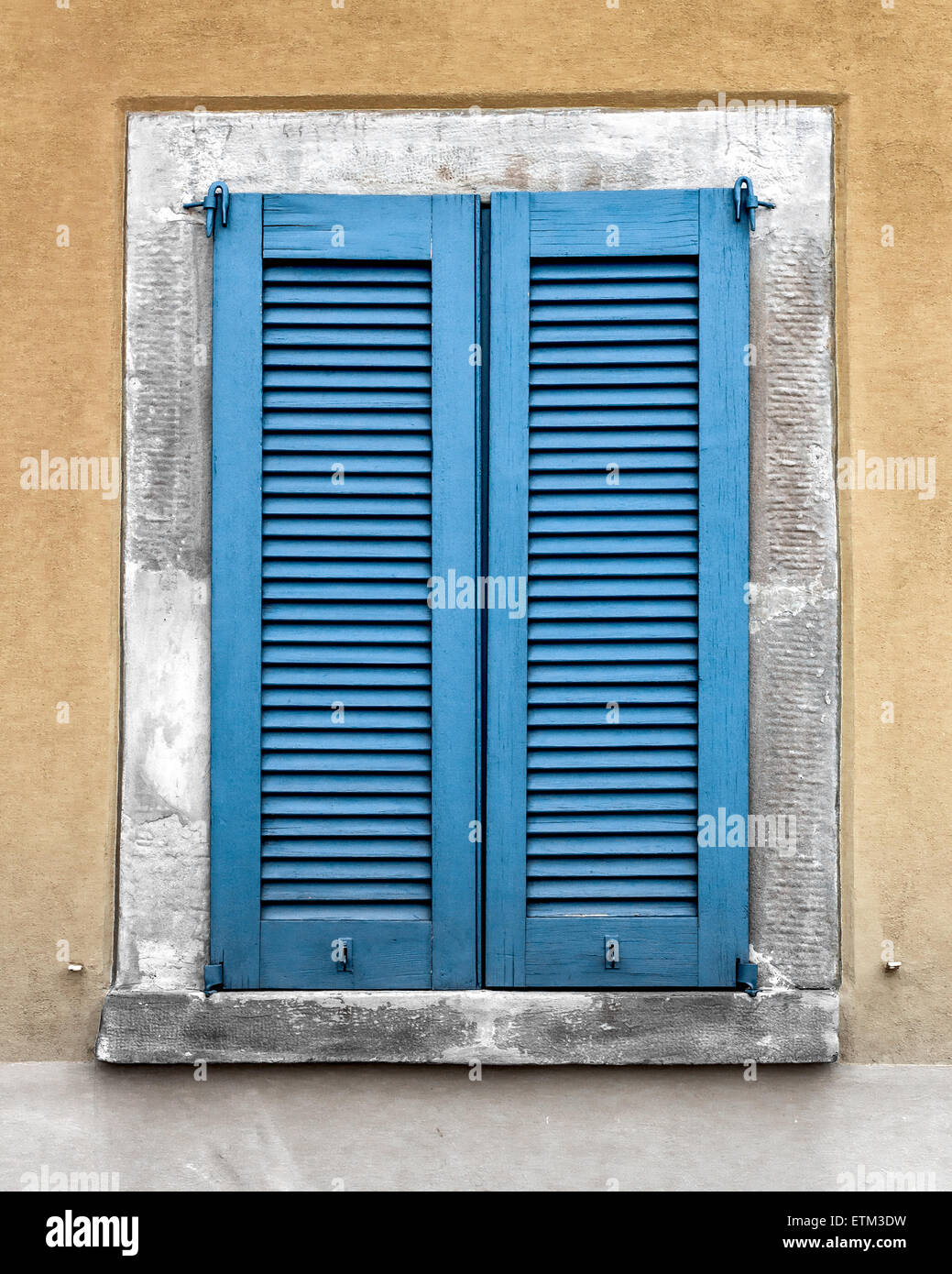 Vertical view of an old blue window on yellow wall Stock Photo - Alamy
