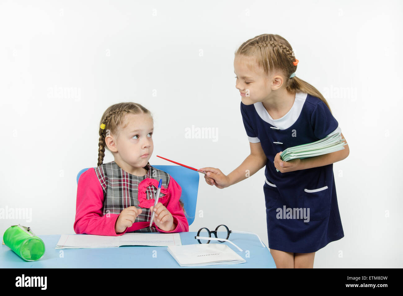 Two girls play school teacher and student Stock Photo - Alamy