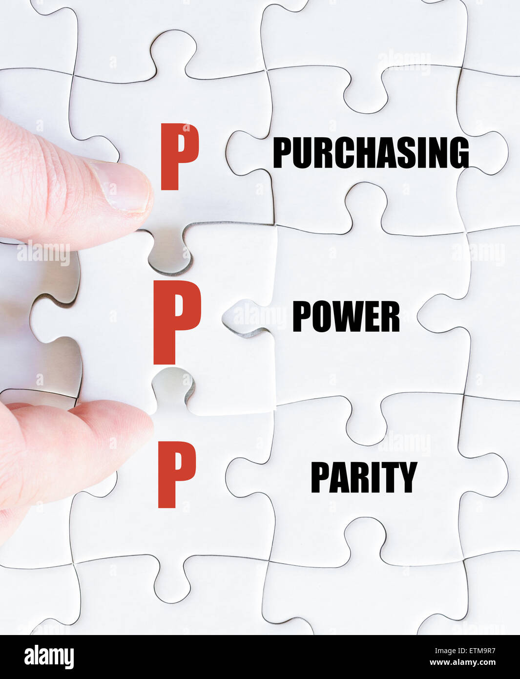 Hand of a business man completing the puzzle with the last missing ...