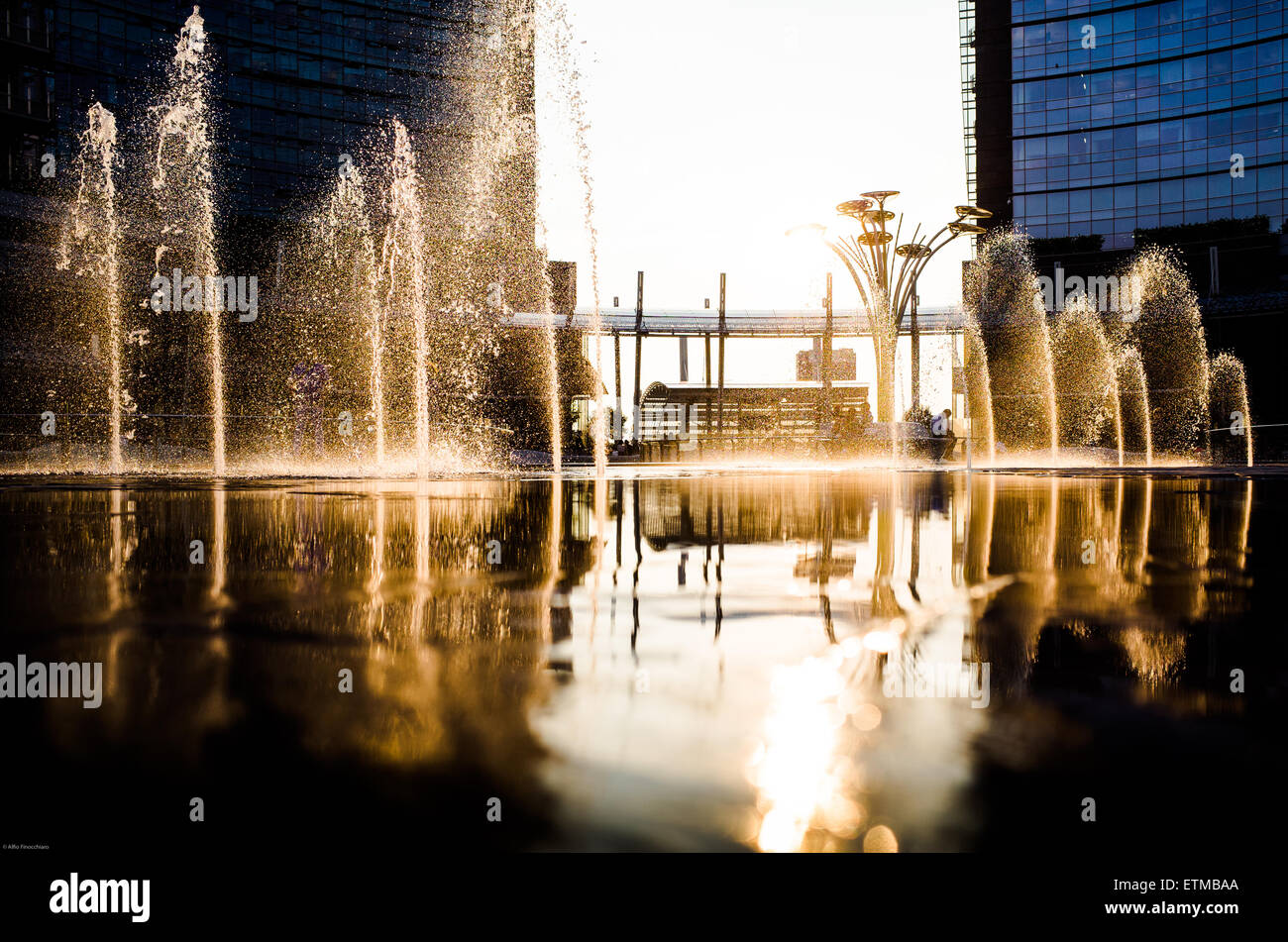 Many fountains splashing water over the square in Milan, Porta Nuova ...
