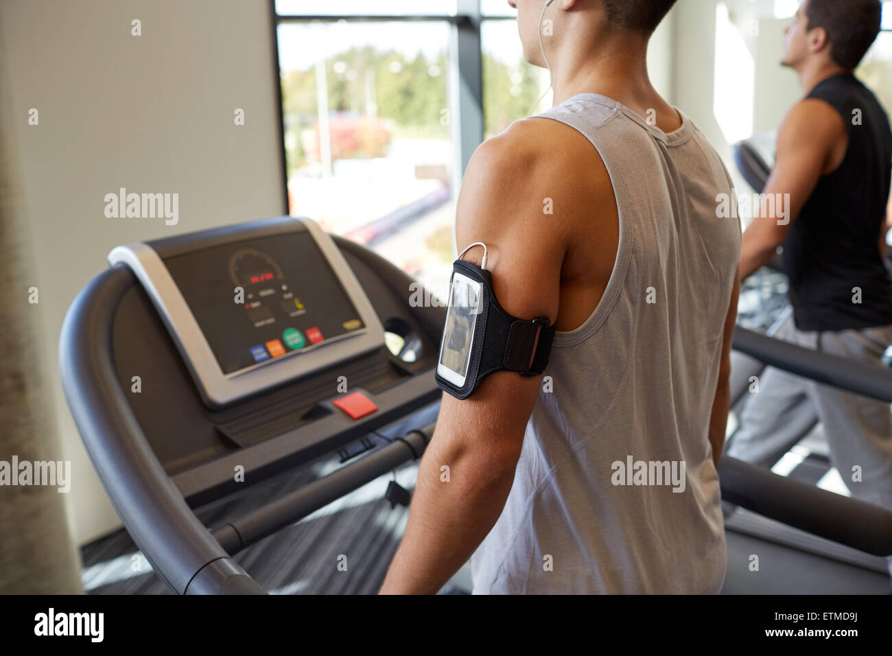smiling men exercising on treadmill in gym Stock Photo - Alamy