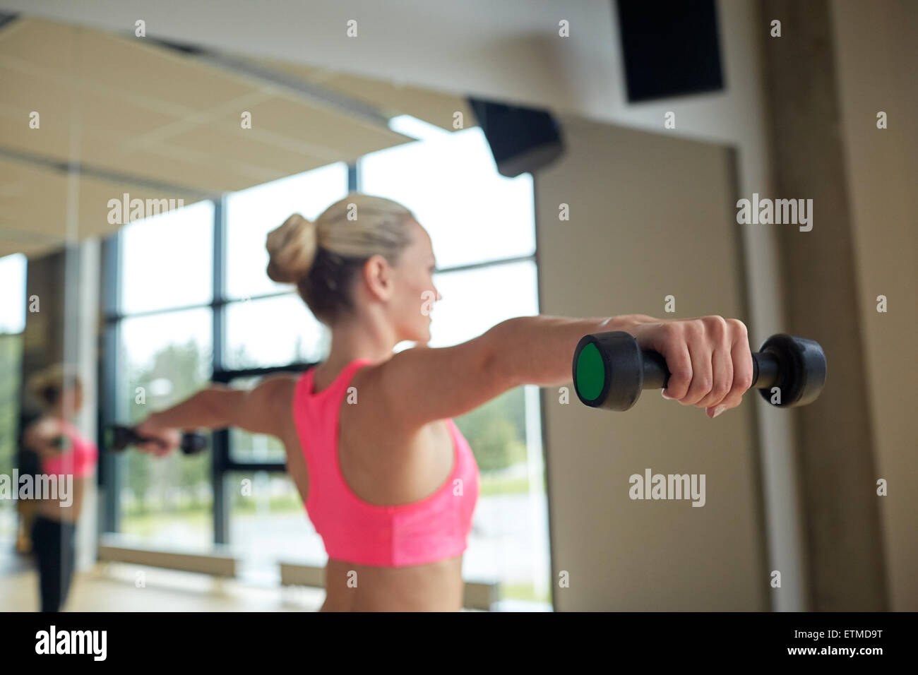 woman with dumbbells flexing muscles in gym Stock Photo - Alamy