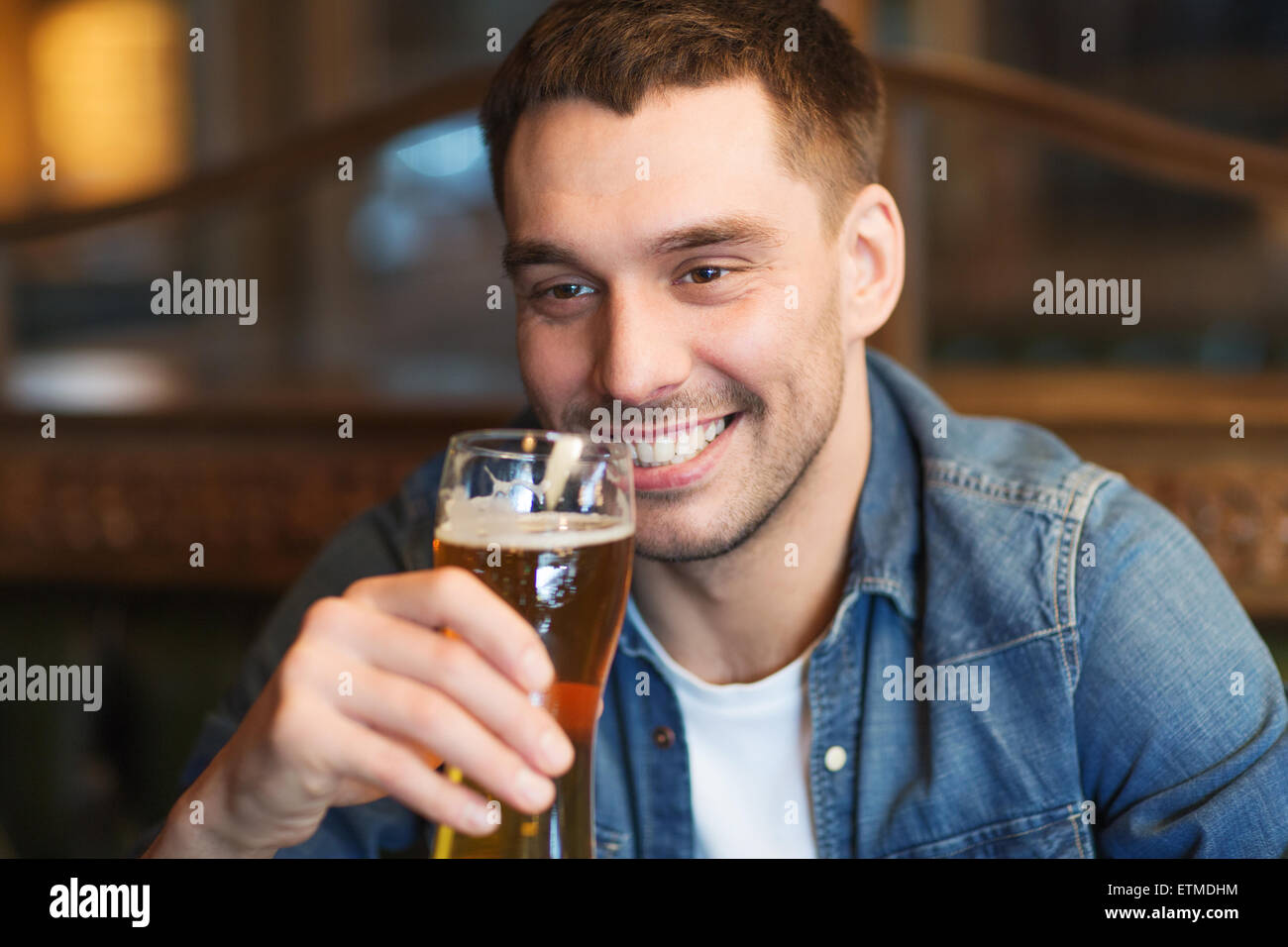 happy man drinking beer at bar or pub Stock Photo - Alamy