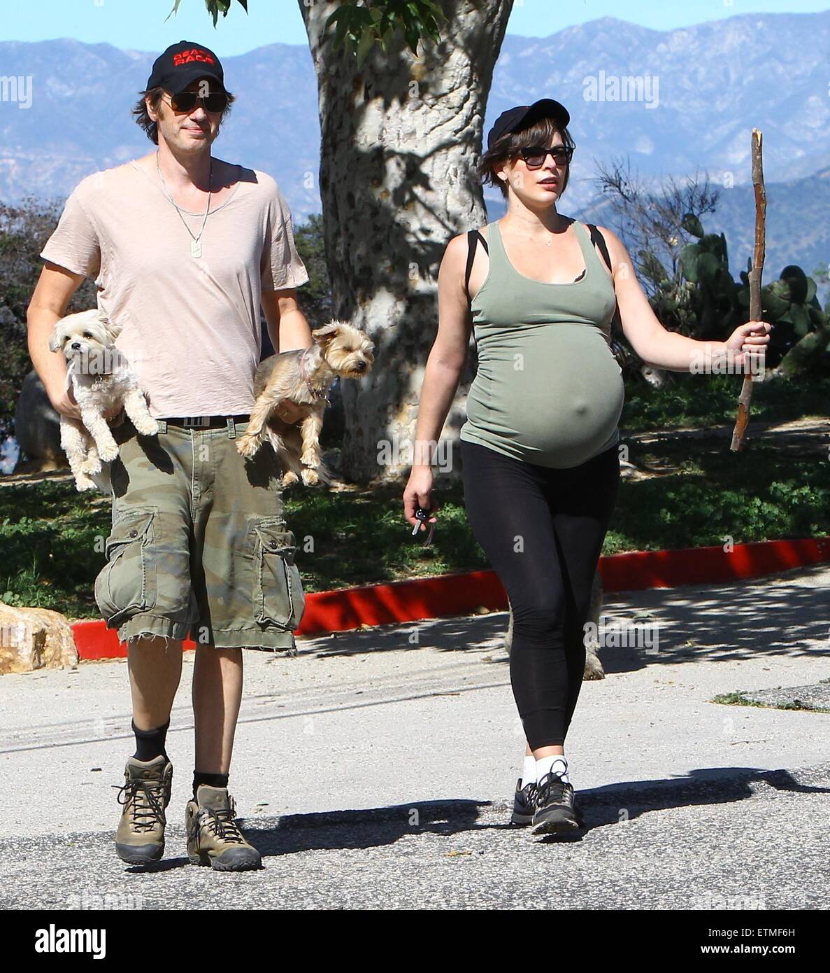 Heavily pregnant Milla Jovovich and her husband Paul go for a walk with ...
